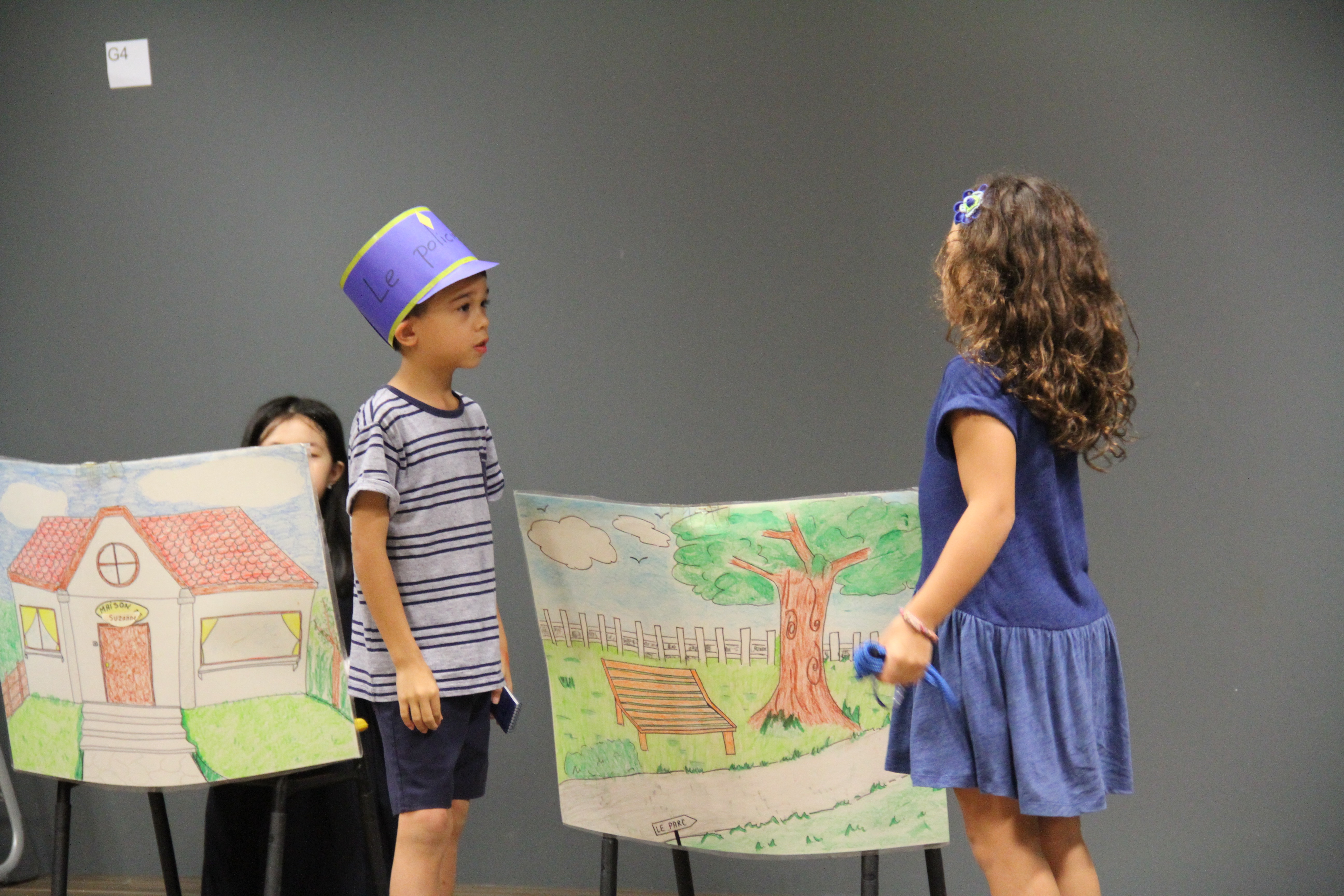 Primary French plays in mini theatre.